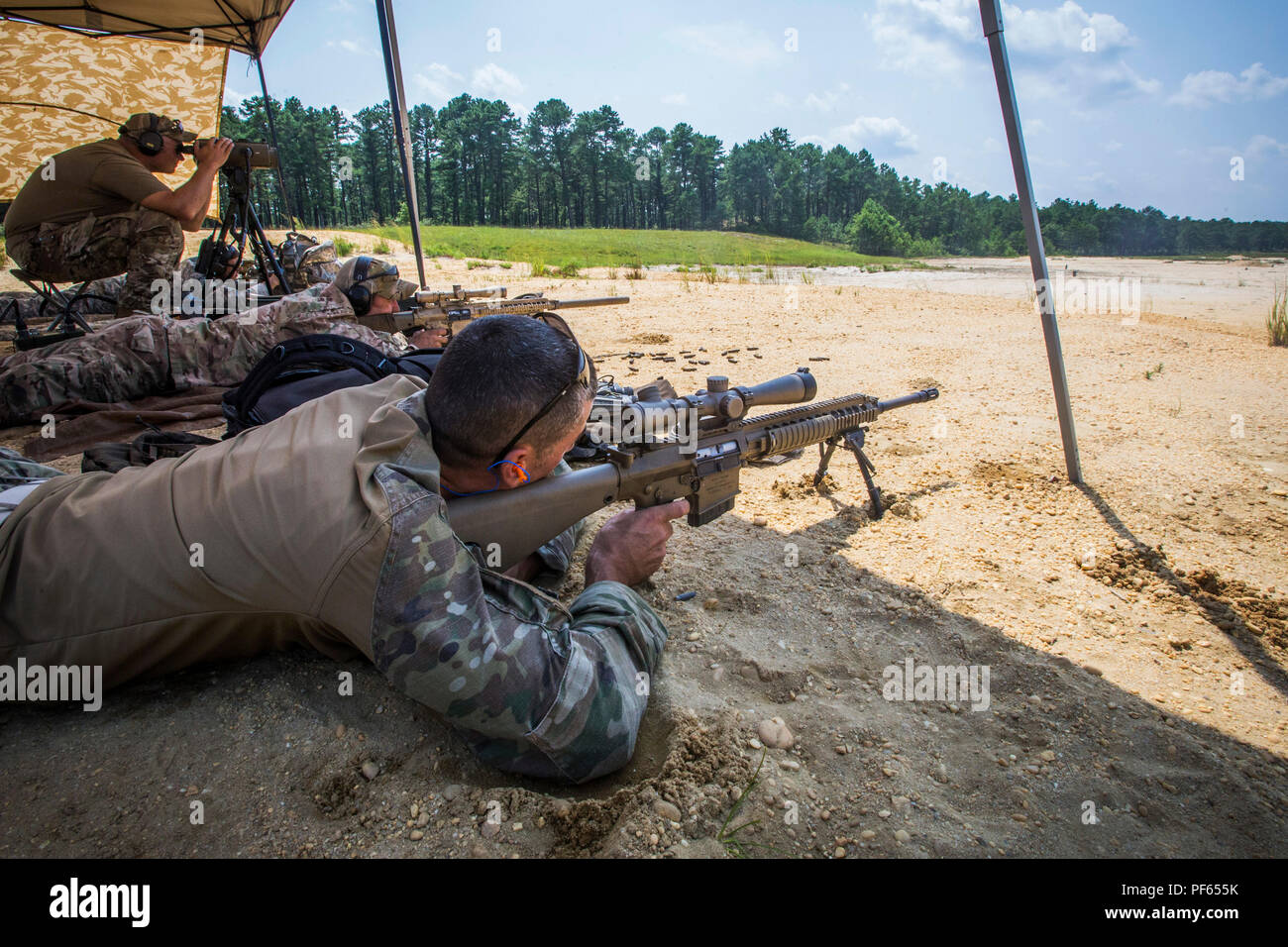 Albanian special forces sniper Staff Sgt. Ajet Disha, front, prepares ...