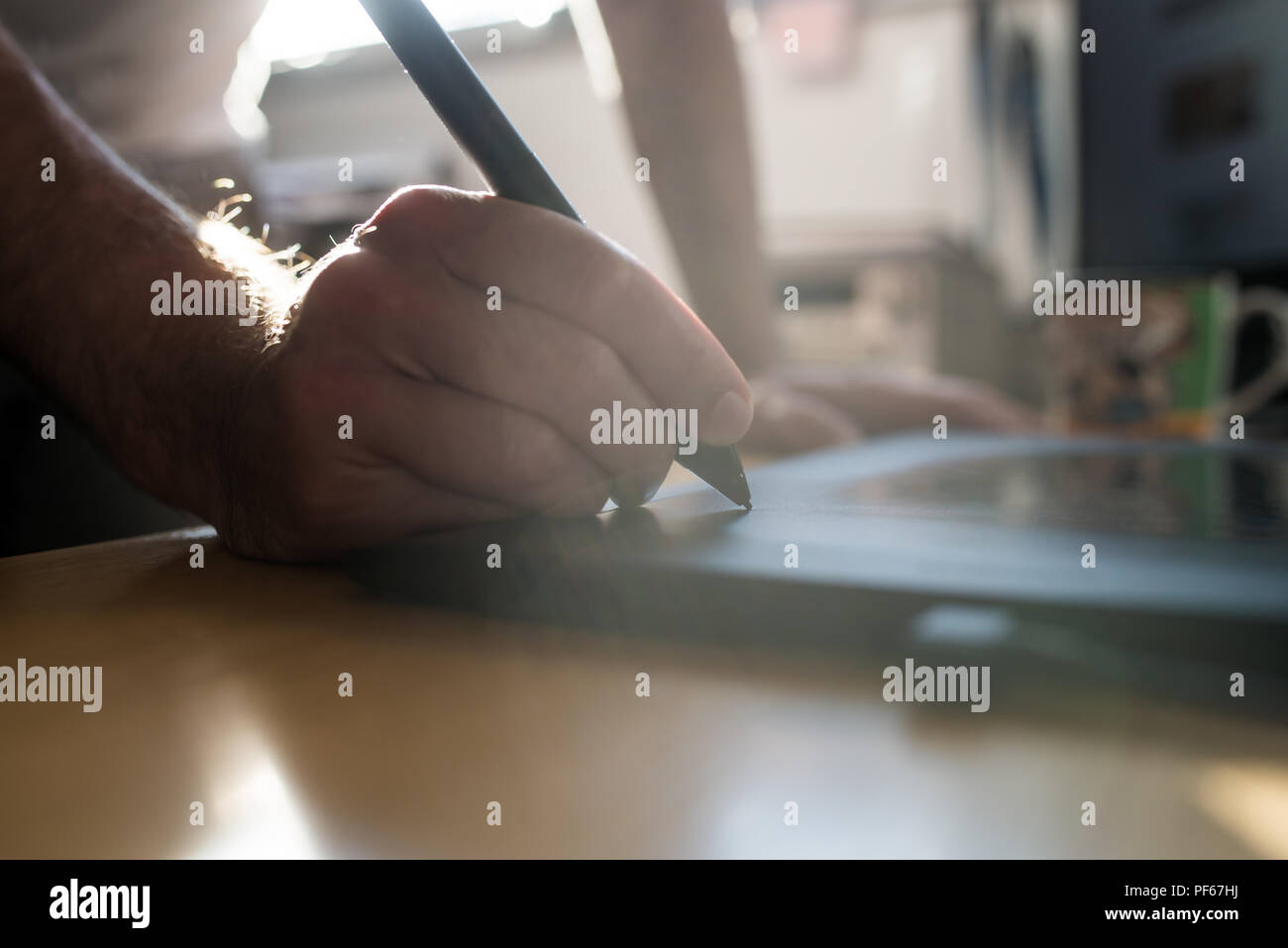 Graphic designer or photographer using a tablet and stylus pen to do ...