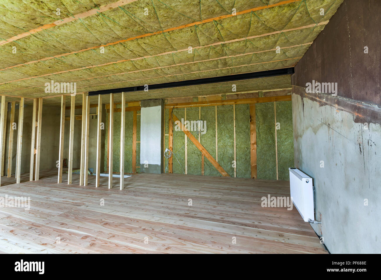 Construction and renovation of big spacious empty unfinished attic room ...