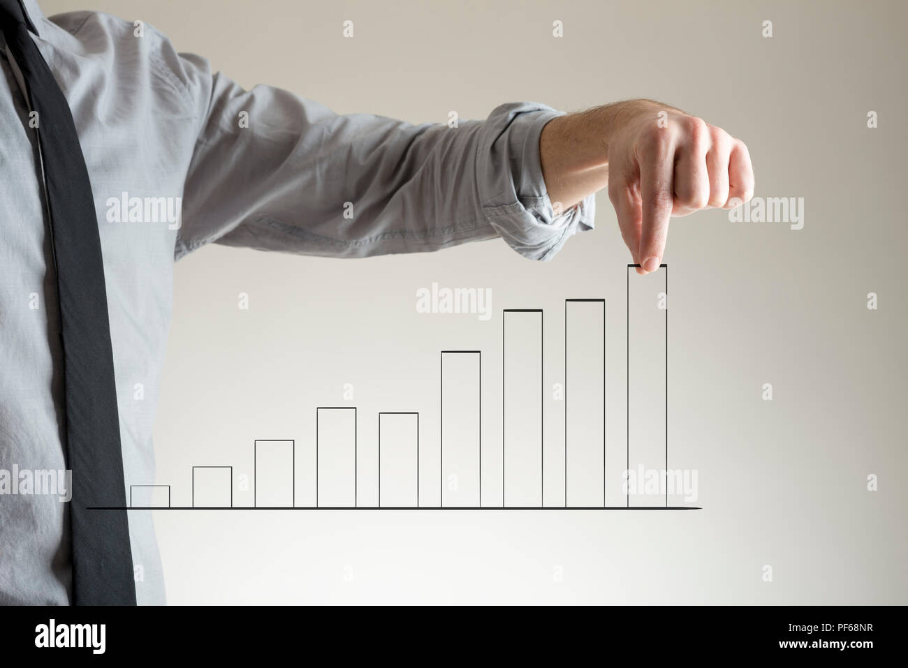 Businessman with growing chart drawing, as if pulling the bar up with ...