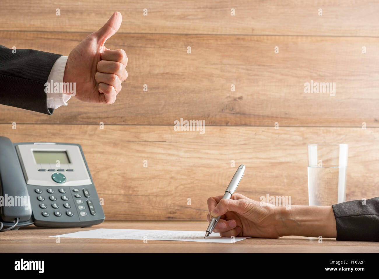 Businessman expressing his approval and satisfaction by making a thumbs ...