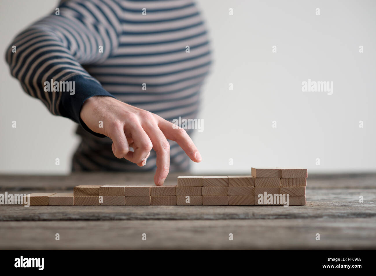 A number of blocks laid out on a table of gradually increasing height ...