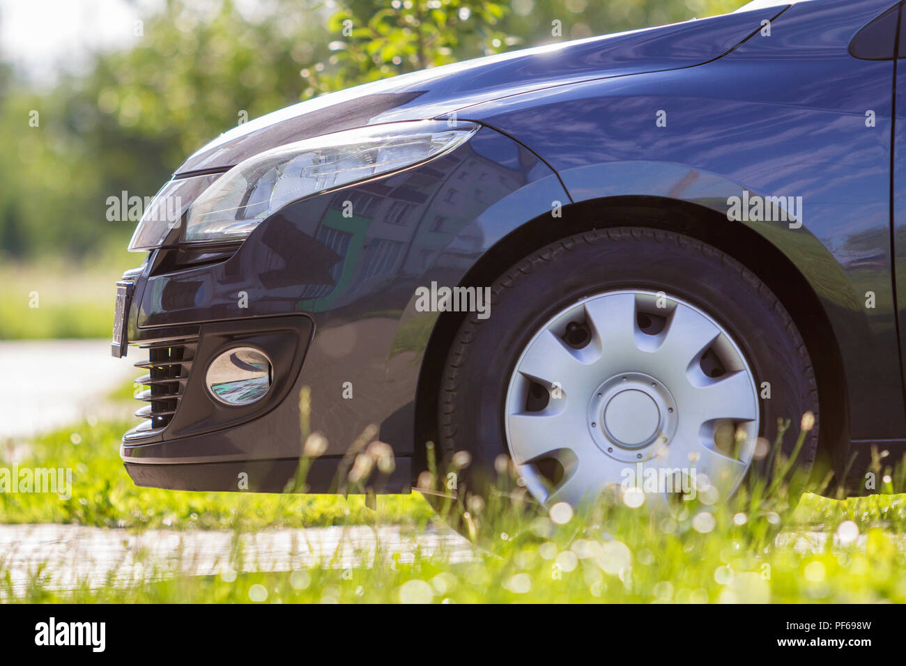 Close-up detail front of modern new shiny empty black car parked ...