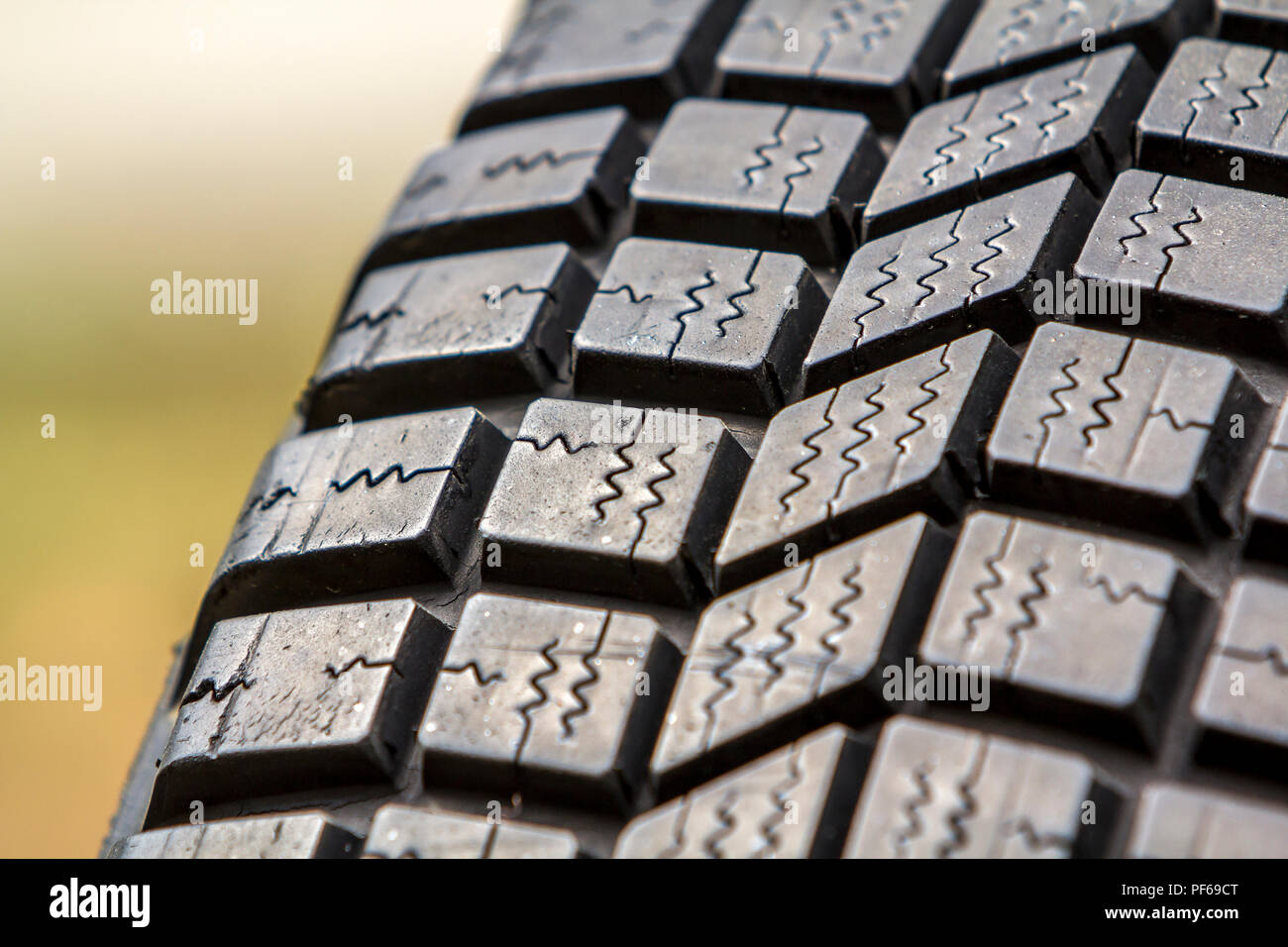 Close up detail part of new black rubber car tire protector, selective ...