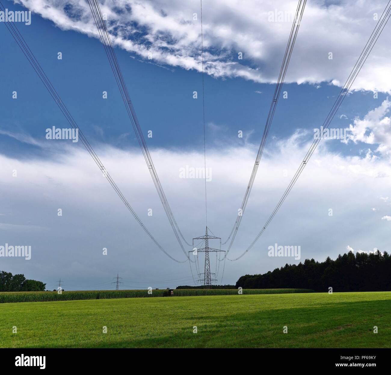 Power supply line pylon in the countryside, blue sky with clouds Stock ...