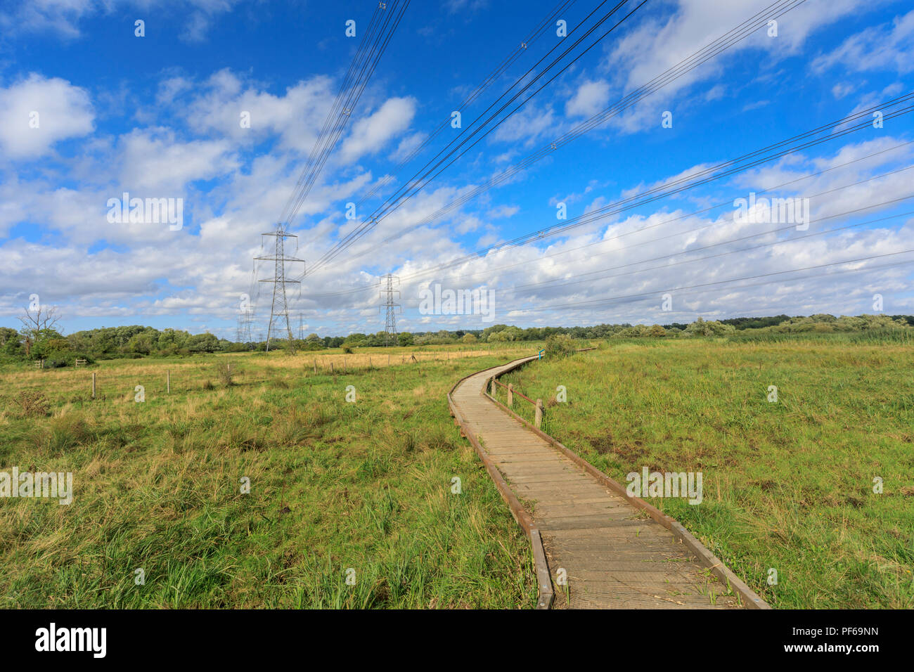 Electricity pylons and boardwalk through the tidal Lower Test Marshes ...