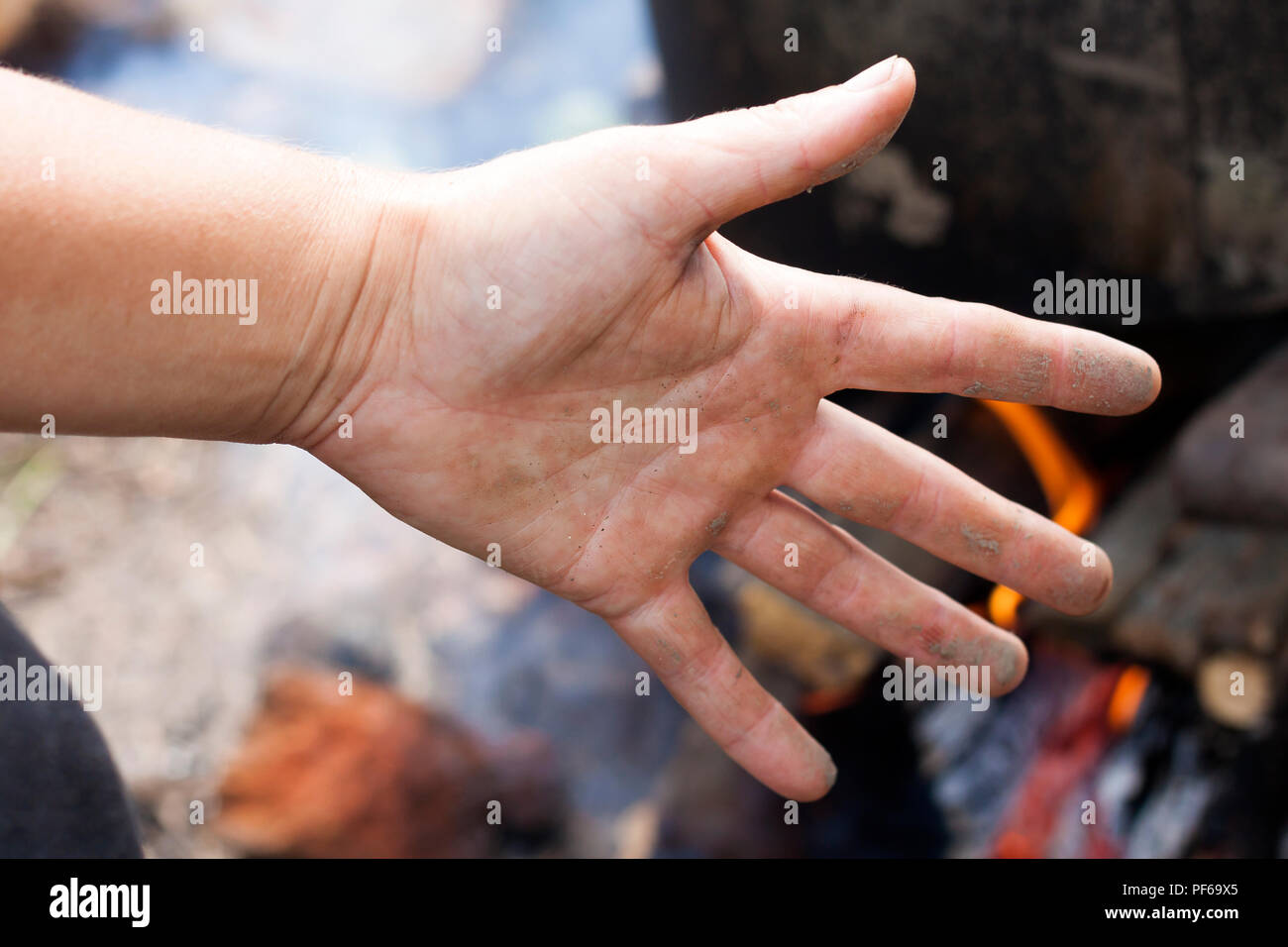 Close-up view of white woman dirty sandy hand palm with spread fingers ...