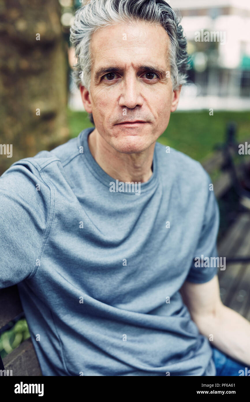 Mature grey haired man sitting hi-res stock photography and images - Alamy