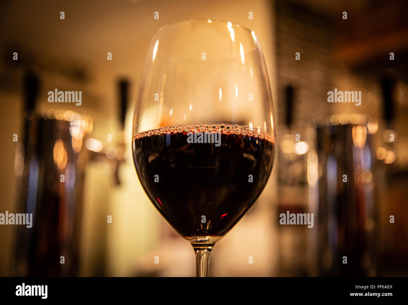 Glass of Red Wine at a Bar Stock Photo - Alamy