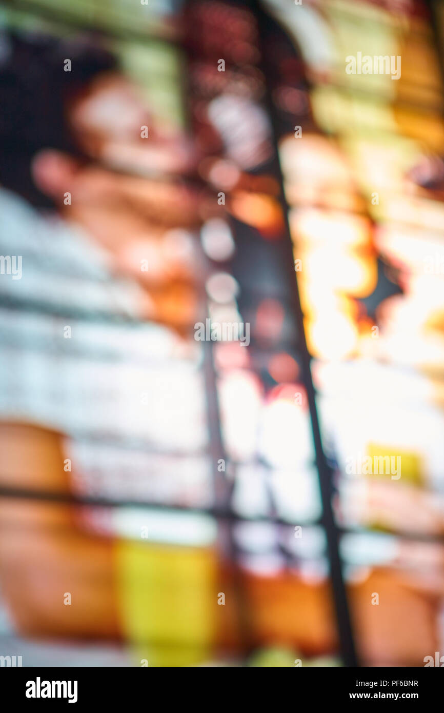 Colourful out of focus illuminated sign or window of out of focus ...