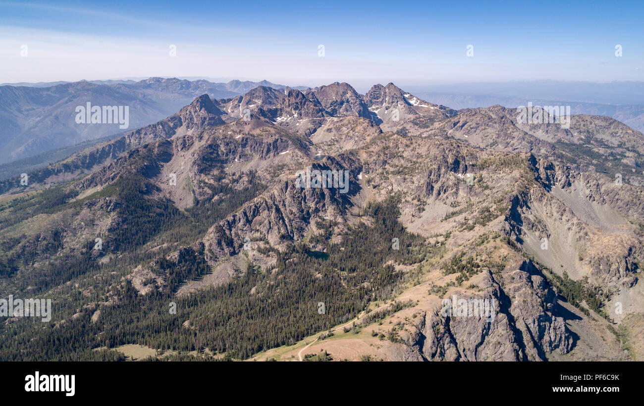 Forest leard to the higher peaks in an Idaho mountain range Stock Photo ...