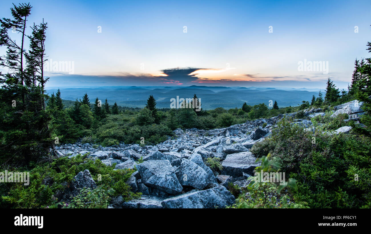 The sun sets behind a giant thunderstorm cloud in the Appalachian Mountains seen from Spruce ...