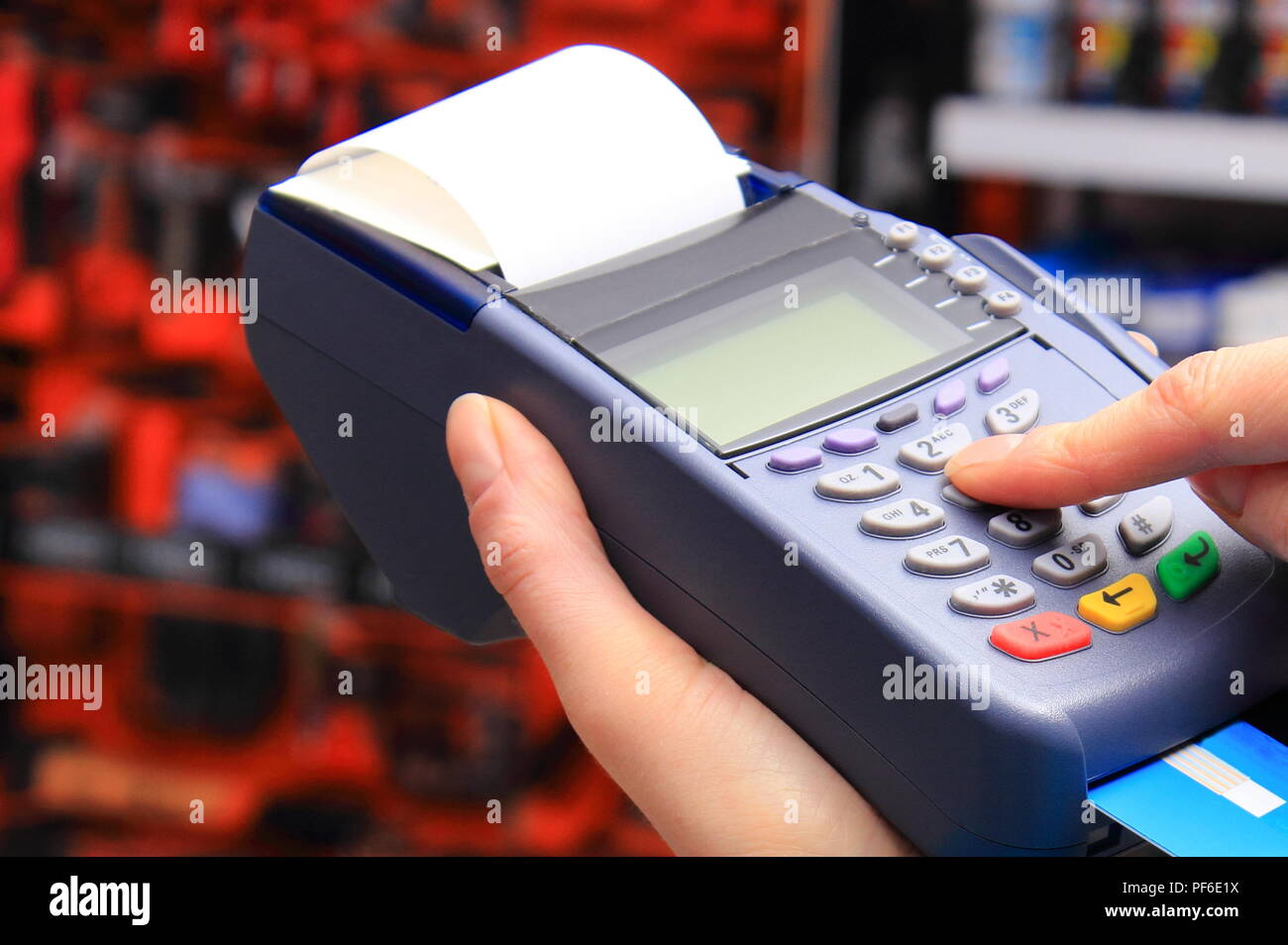 Hand of woman using payment terminal in shop, paying with credit card ...