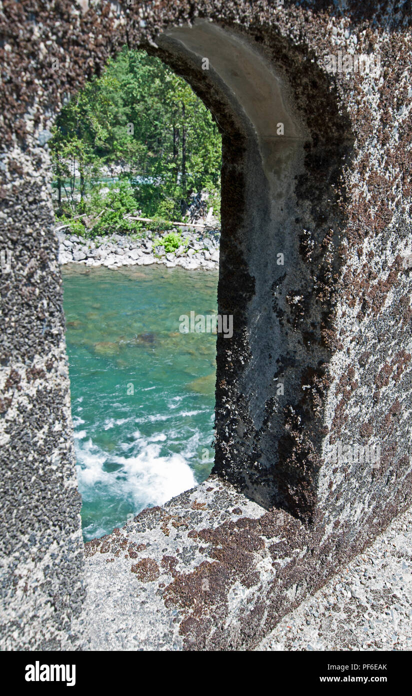 Cool portal window of a bridge that is rustic with moss and texture in ...