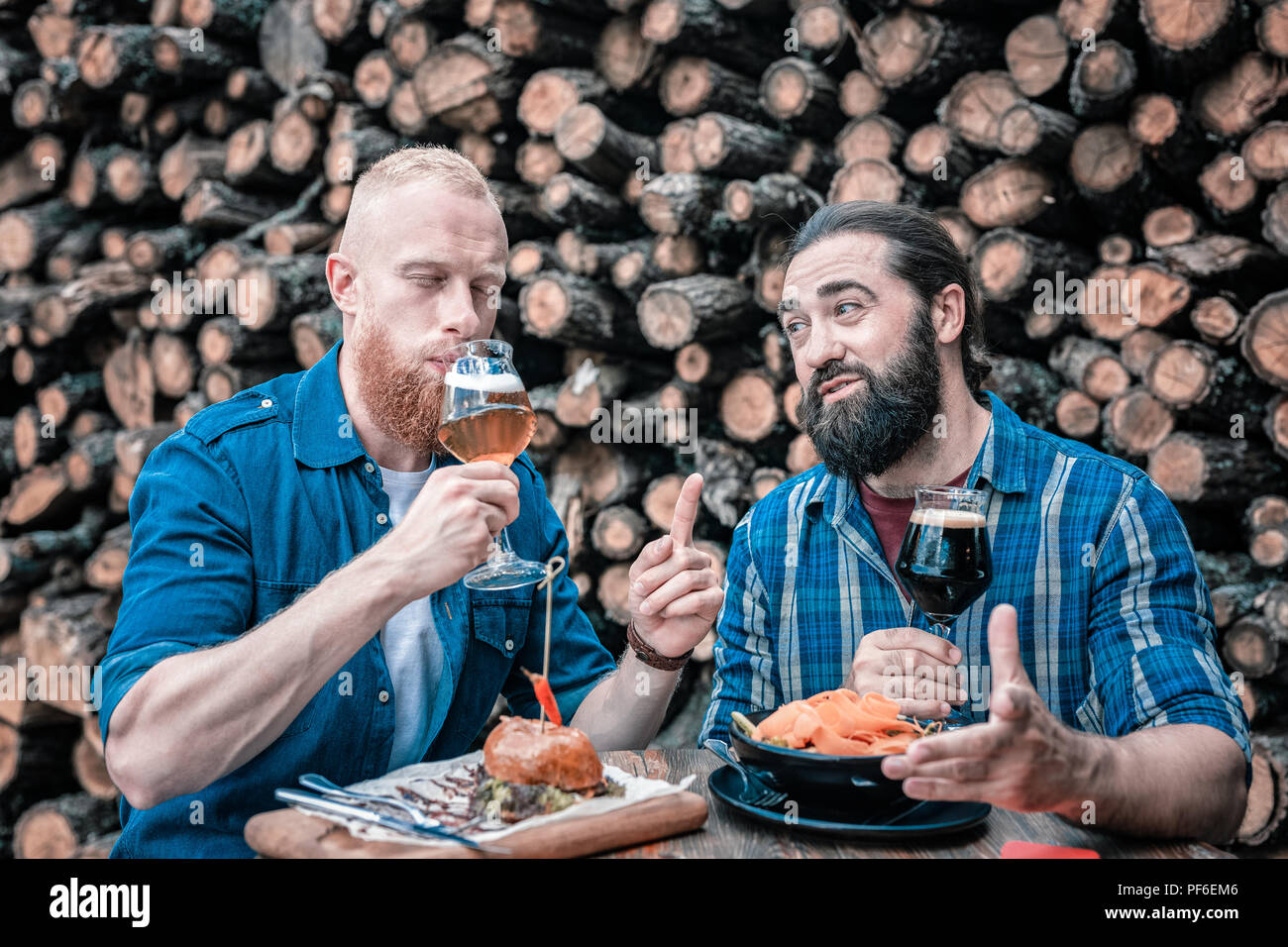 Men fond of gastronomy enjoying nice craft beer with snacks Stock Photo ...