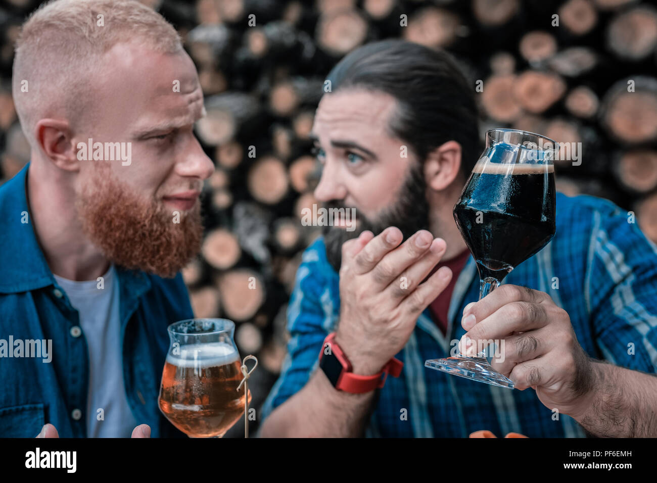 Two friends communicating while having some craft beer Stock Photo - Alamy