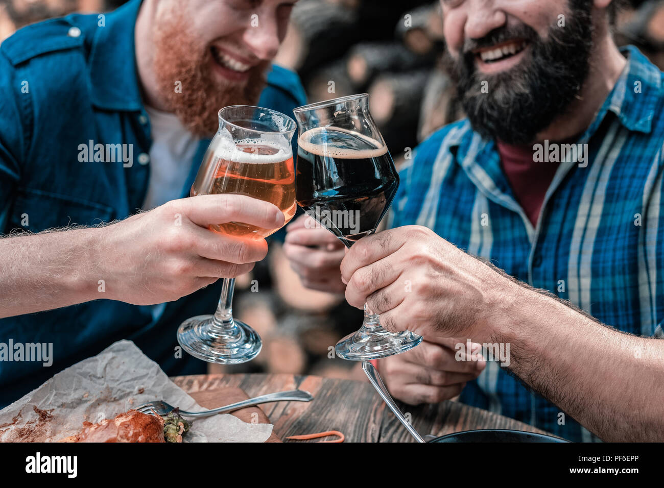 Two businessmen laughing while drinking tasty beer Stock Photo - Alamy