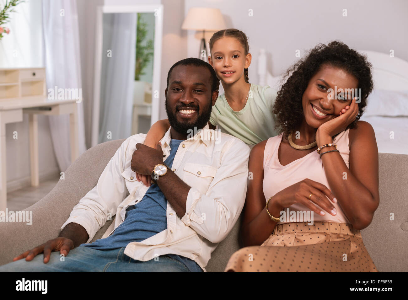 Positive nice family looking at you at home Stock Photo - Alamy