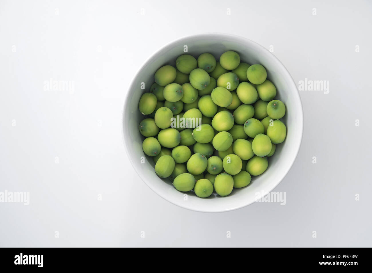 fresh lotus seeds in a cup isolated on white background Stock Photo - Alamy