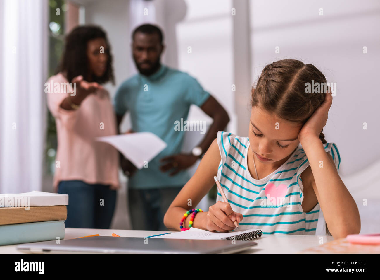 Smart nice girl doing a home task at home Stock Photo - Alamy