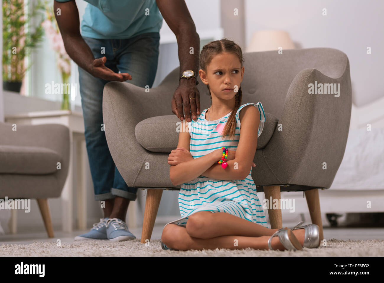 Angry upset girl sitting on the floor Stock Photo - Alamy