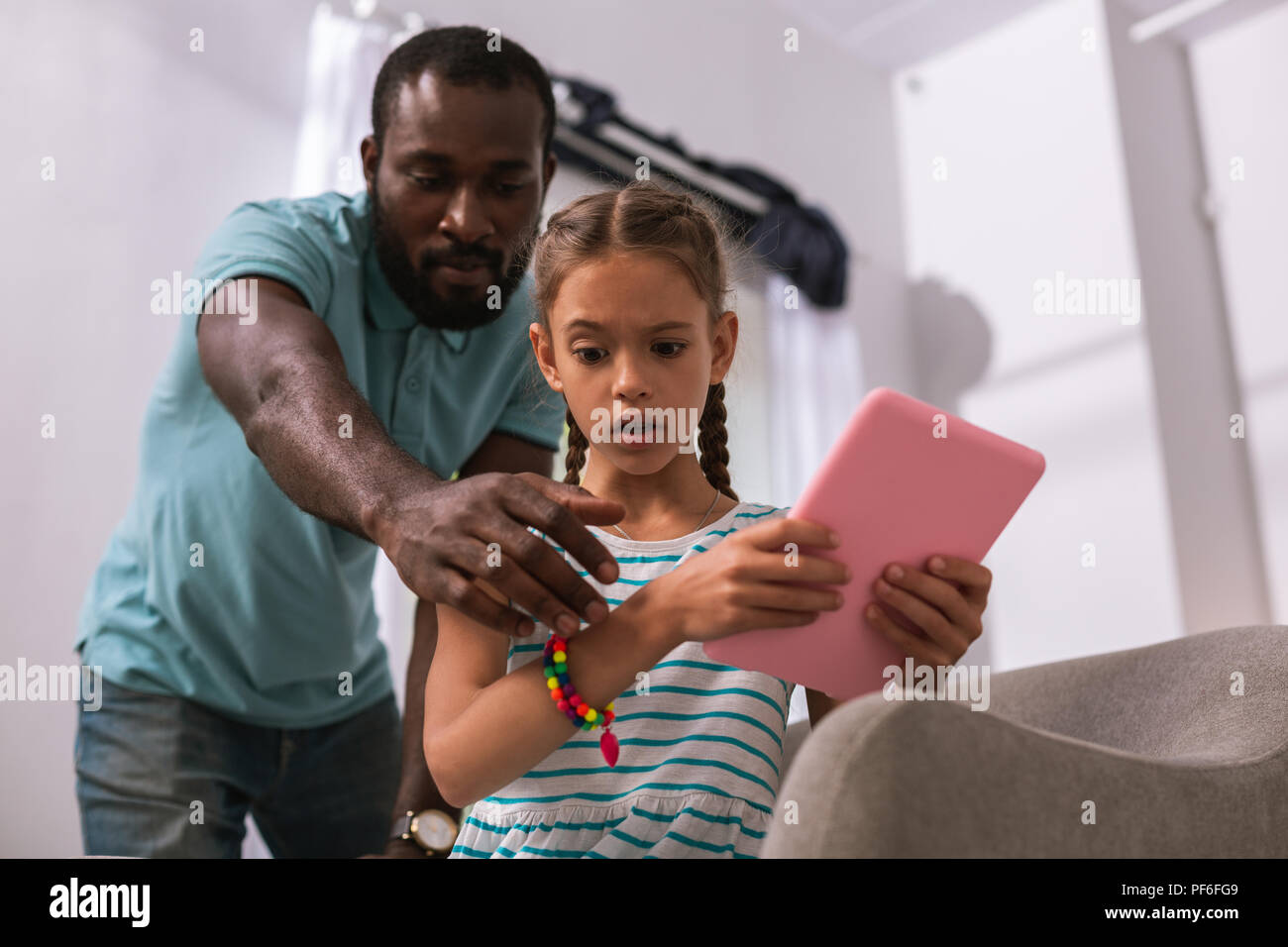Nice strict father taking away the tablet Stock Photo - Alamy