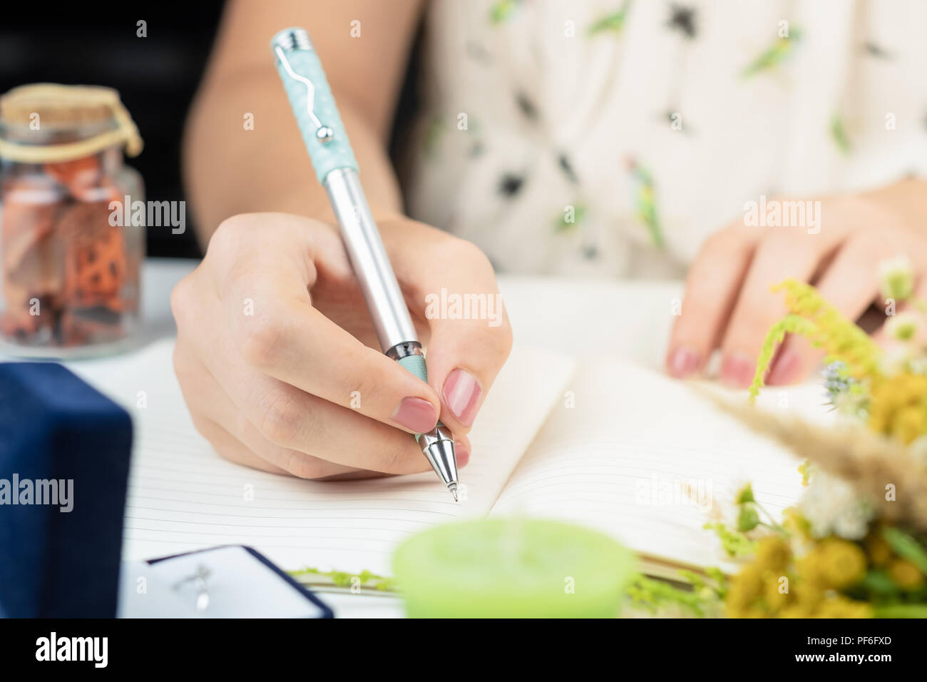 Writing memories and emotions into diary Stock Photo - Alamy