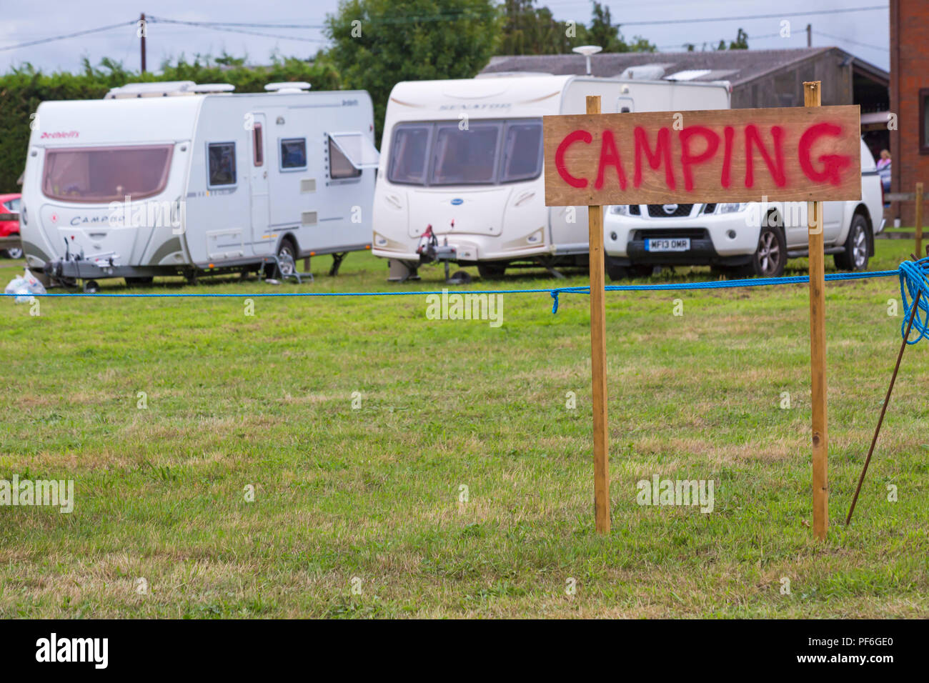 Camping hand painted sign with caravans behind at Horton, Dorset UK in ...