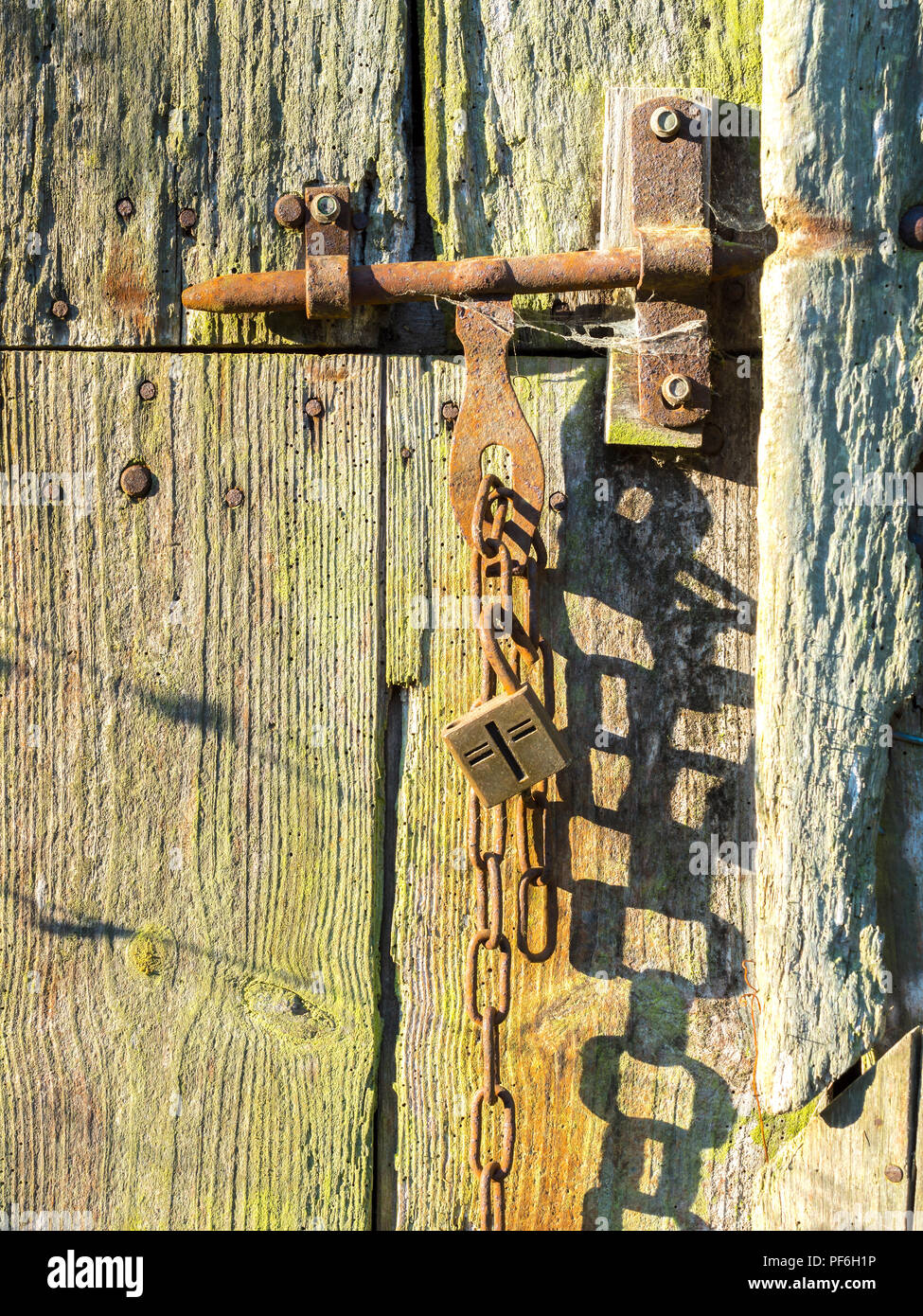 Old lock and chain on weathered barn door - France Stock Photo - Alamy