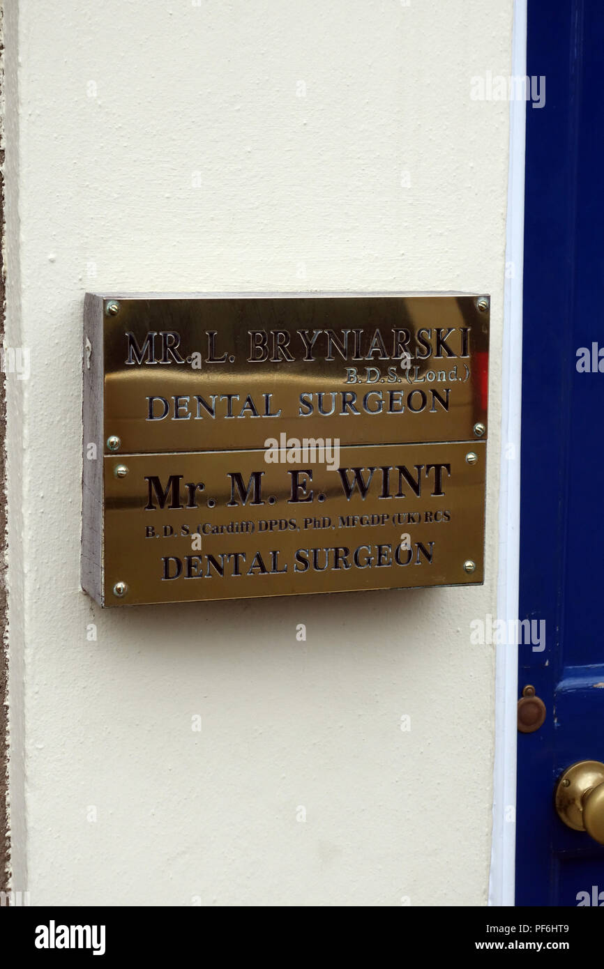 Dentist Surgery Brass door sign on exterior building wall Stock Photo ...