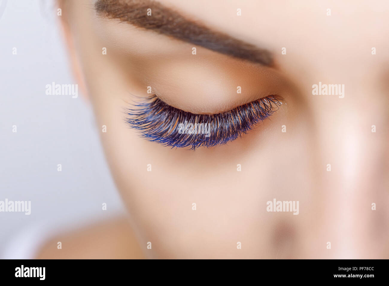 Eyelash Extension Procedure. Woman Eye with Long Blue Eyelashes. Ombre ...