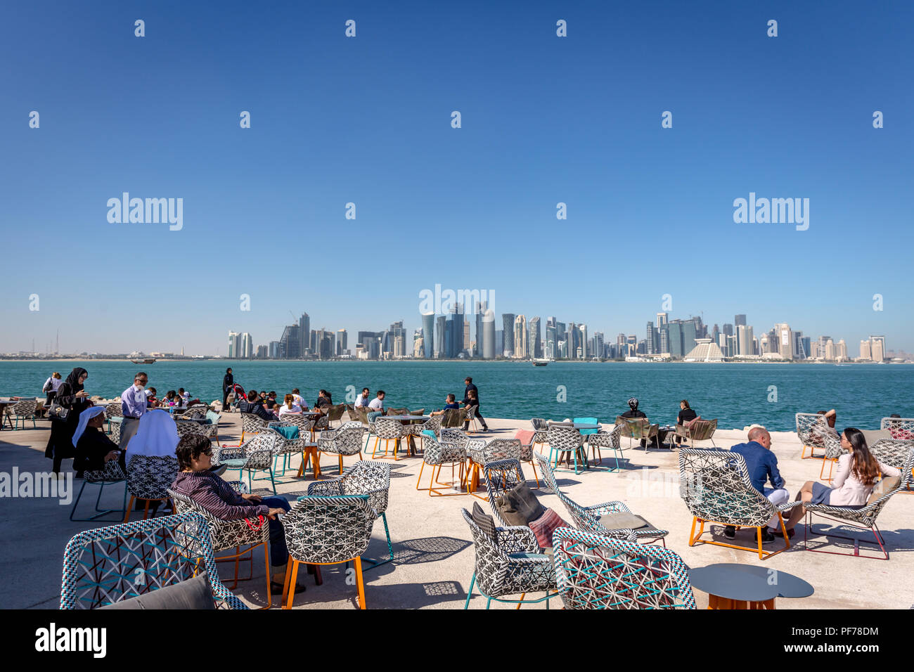 Doha, Qatar - Jan 8th 2018 - Locals and tourists enjoying a cafe bar ...