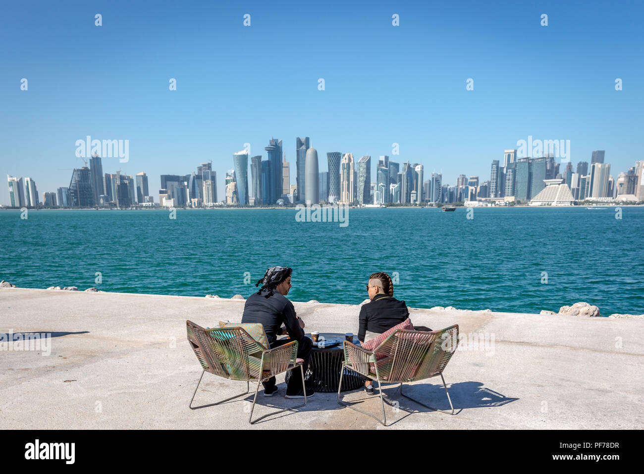 Doha, Qatar - Jan 8th 2018 - Locals and tourists enjoying a cafe bar ...