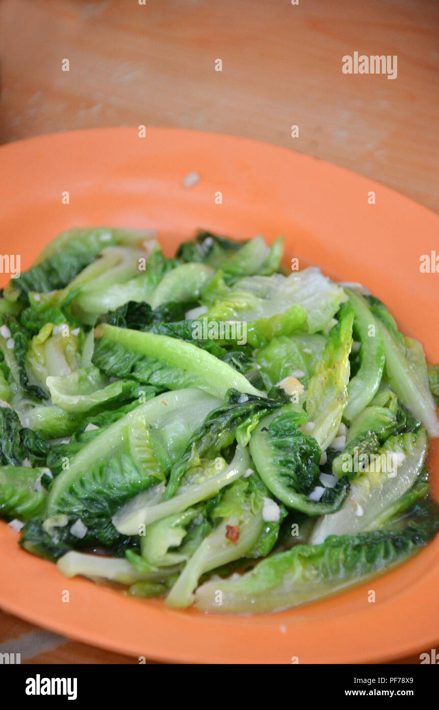 Chinese style fried lettuce served in restaurant Stock Photo - Alamy