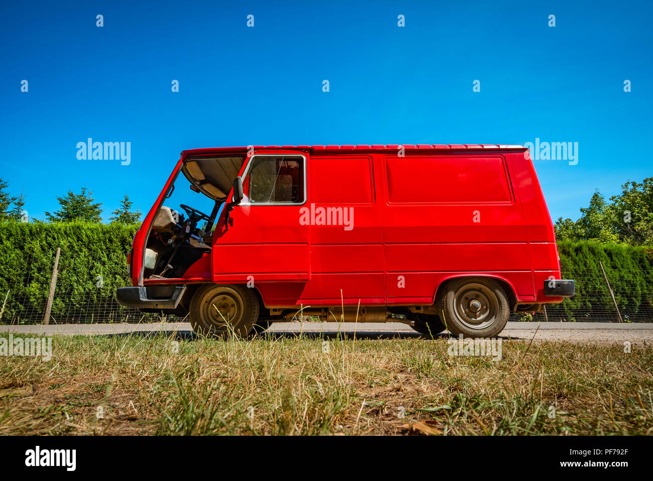 Old retro red minibus on blue sky background, sunny day Stock Photo - Alamy
