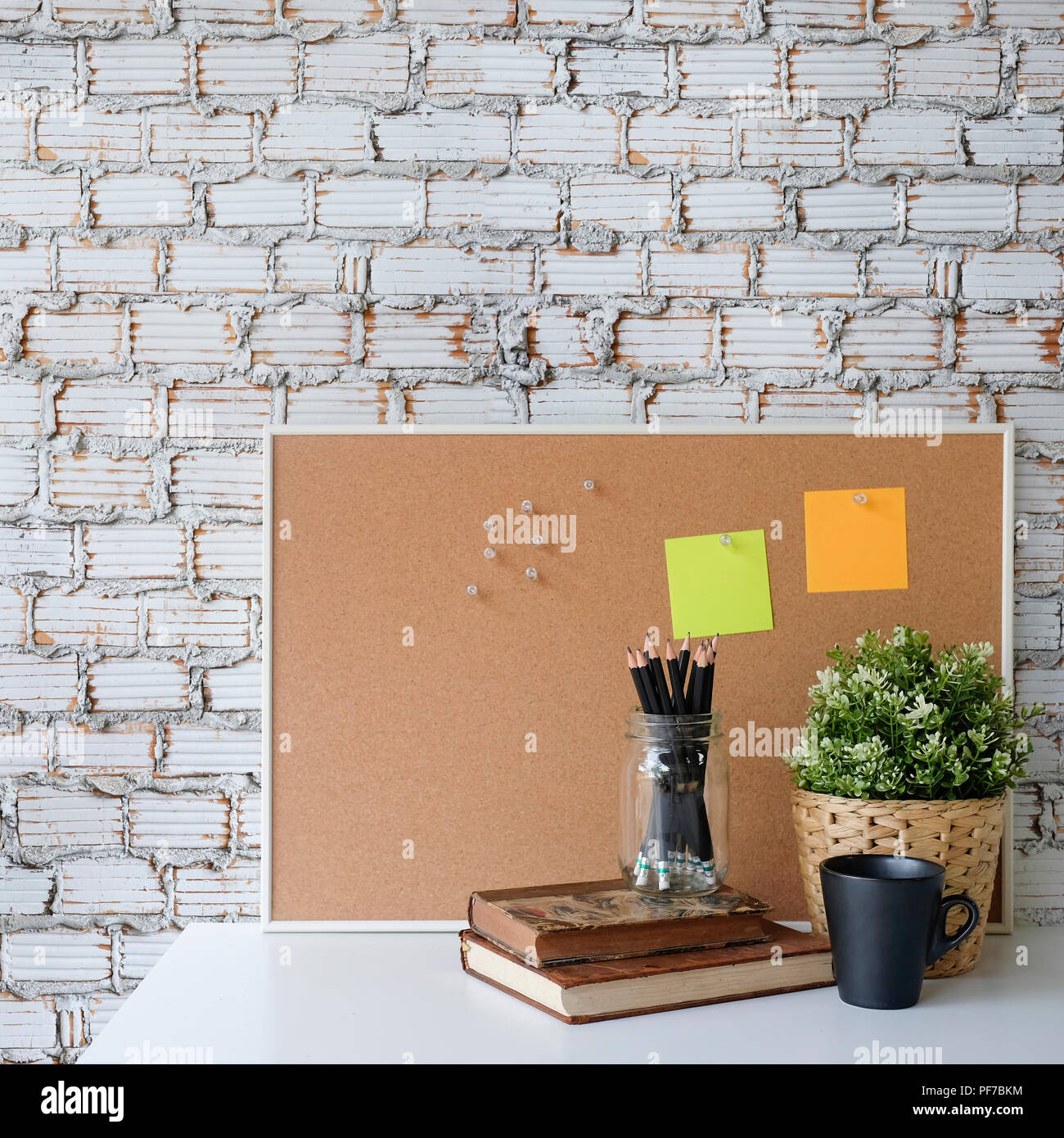Stylish table Board and post it, book, pencil and coffee mug on table ...