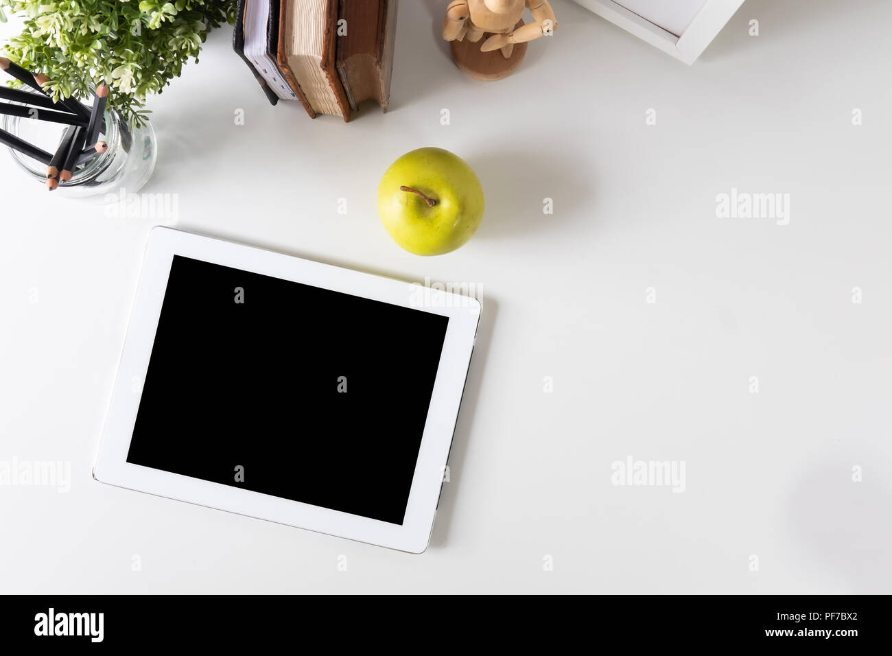 Mockup tablet digital on workspace with top view table Stock Photo - Alamy