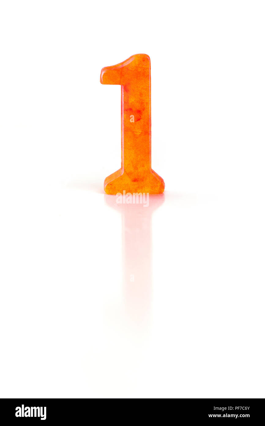 A photo of a golden orange number one on a white background with ...