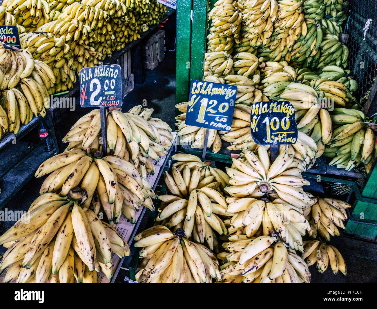 Sale of bananas in the market with signs that say the type of banana ...