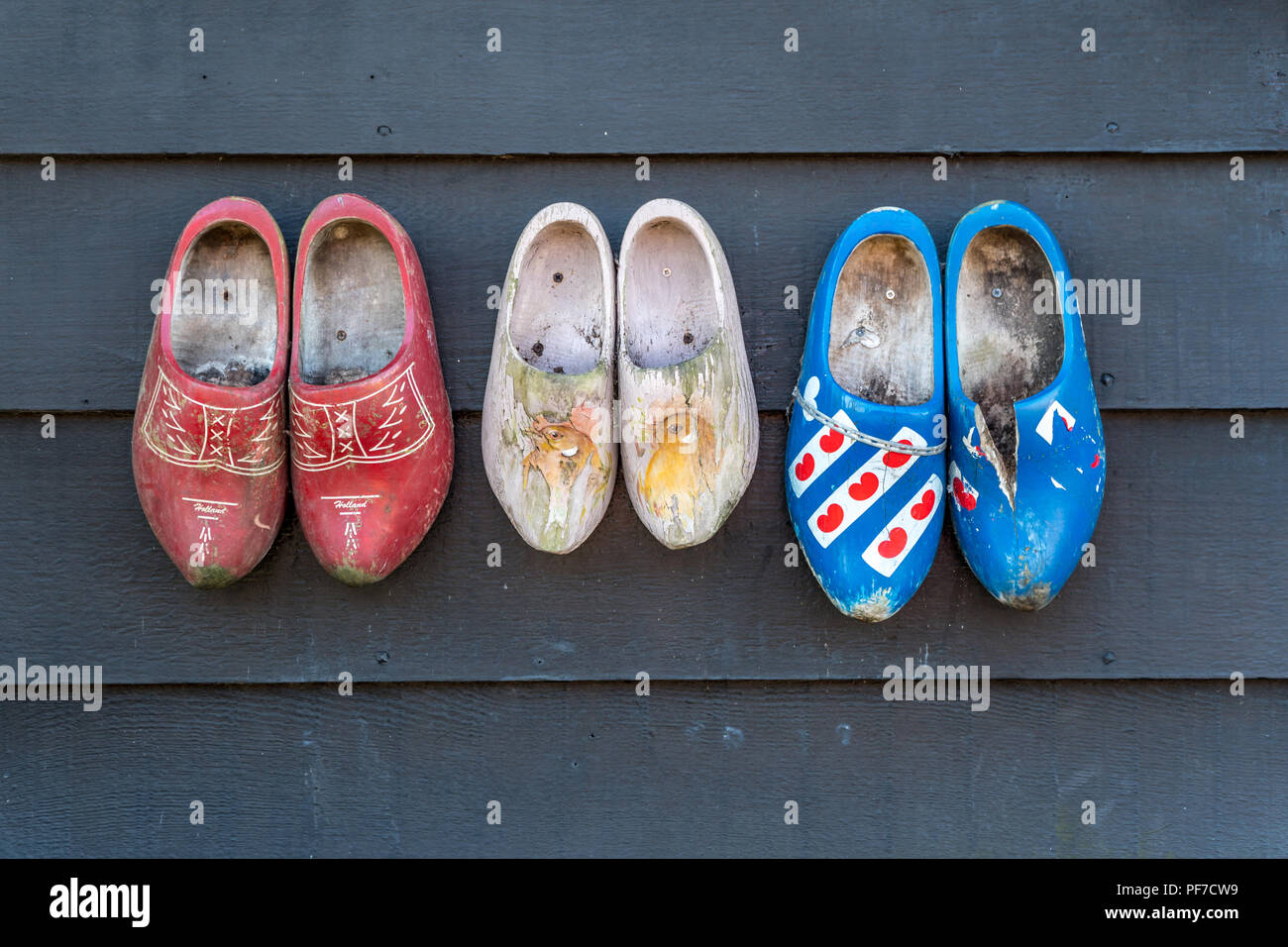 Traditional dutch wooden clogs hanging at a wall in Netherlands Stock ...