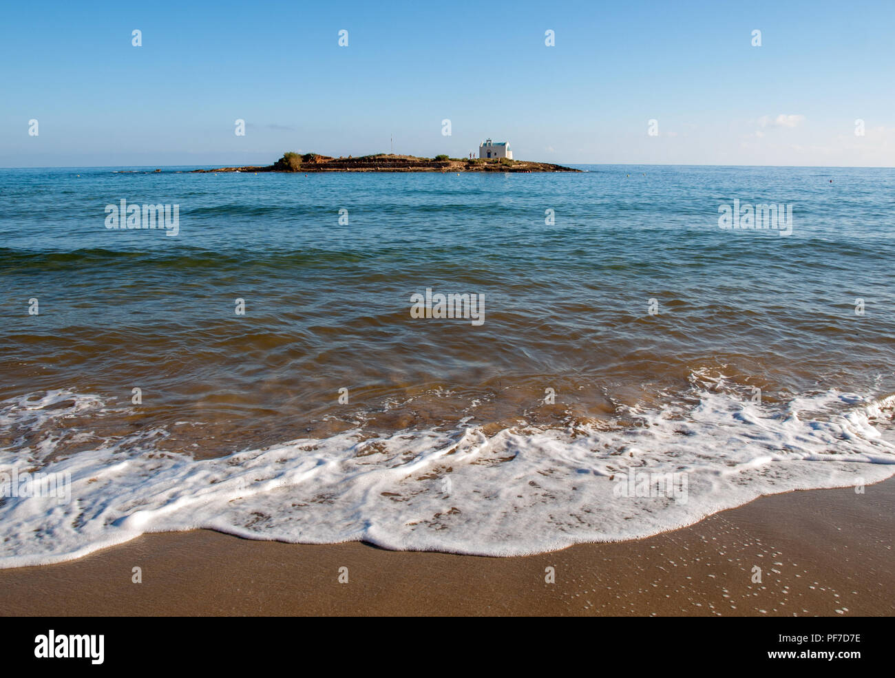Picturesque small Chapel on island across Malia beach, Crete. Greece ...