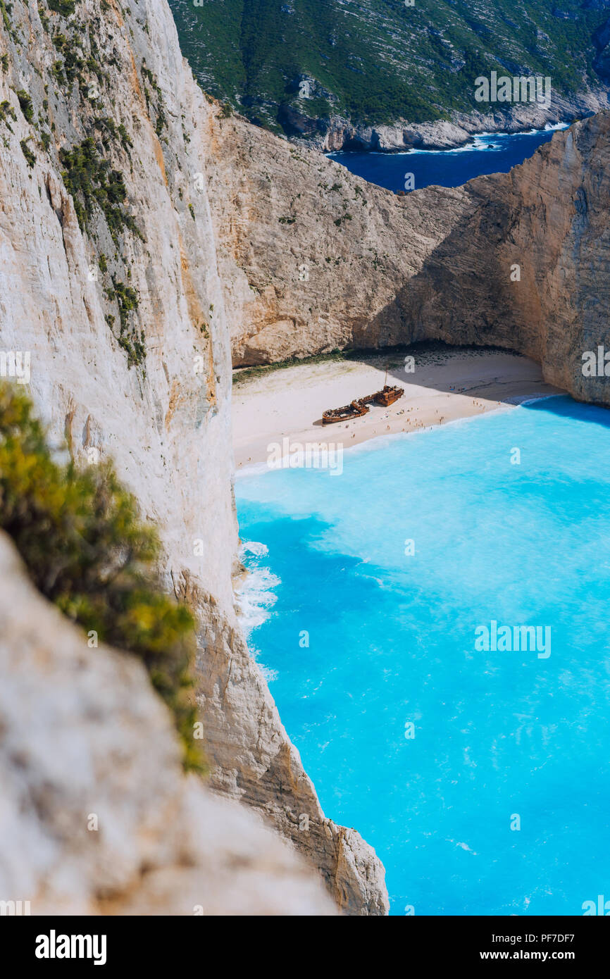 Limestone chalk colored like huge cliff rocks surrounding Navagio beach ...
