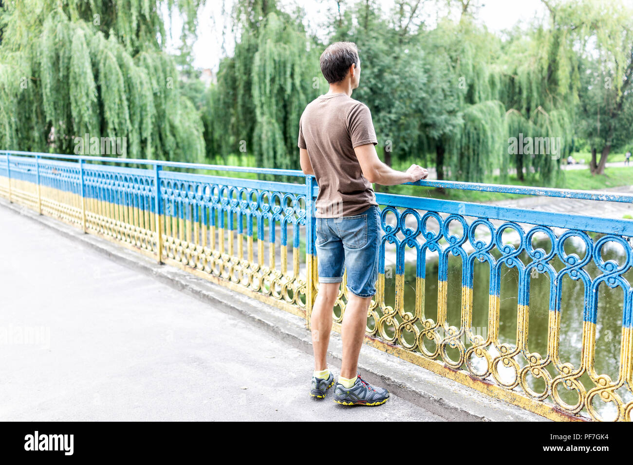 Man leaning on bridge railing hi-res stock photography and images - Alamy