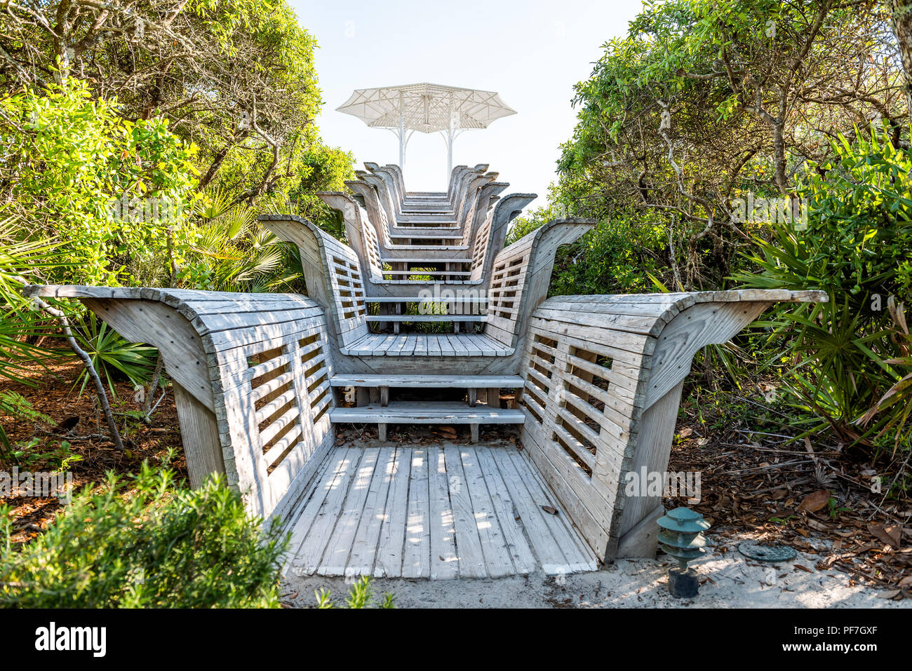 Closeup of wooden pavilion stairs leading to beach ocean with umbrella ...