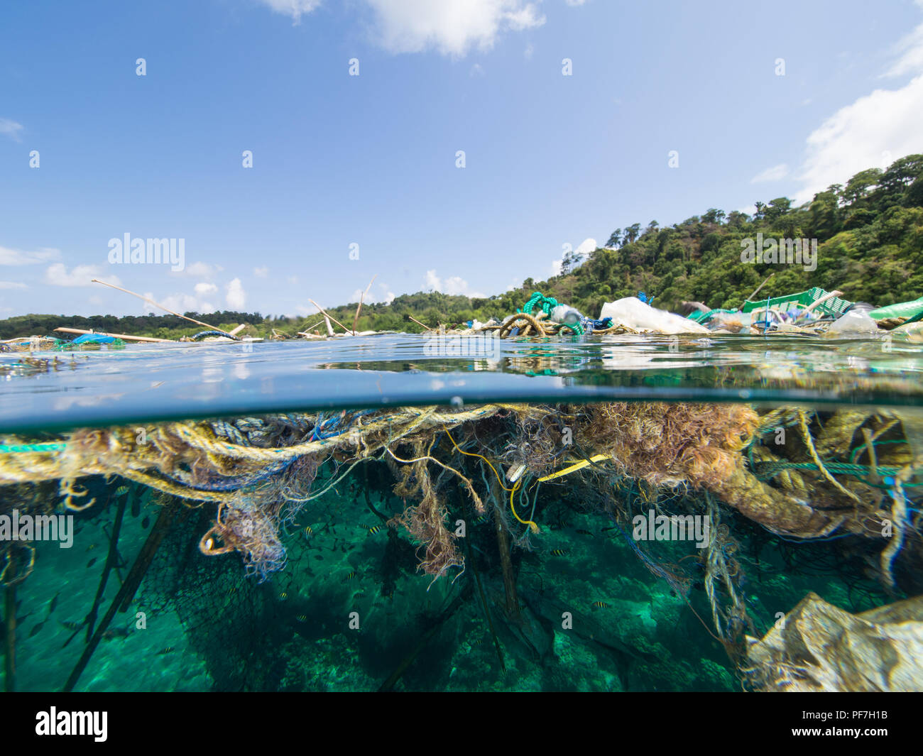 Split shot over/under of a big patch of ropes and garbage floating on ...