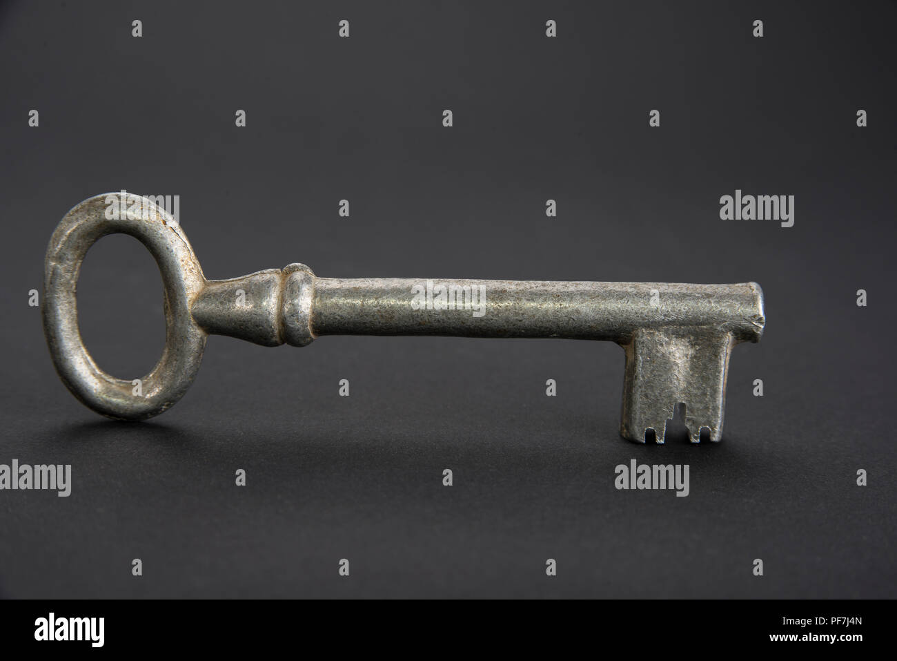 Old vintage key on the black background Stock Photo - Alamy