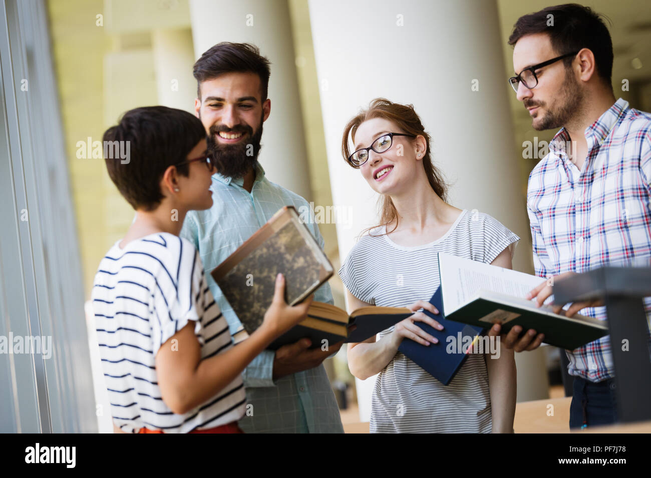Group of Young Students Studying together at Library Stock Photo - Alamy
