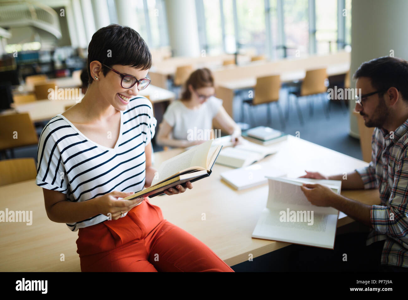 Group of Young Students Studying together at Library Stock Photo - Alamy