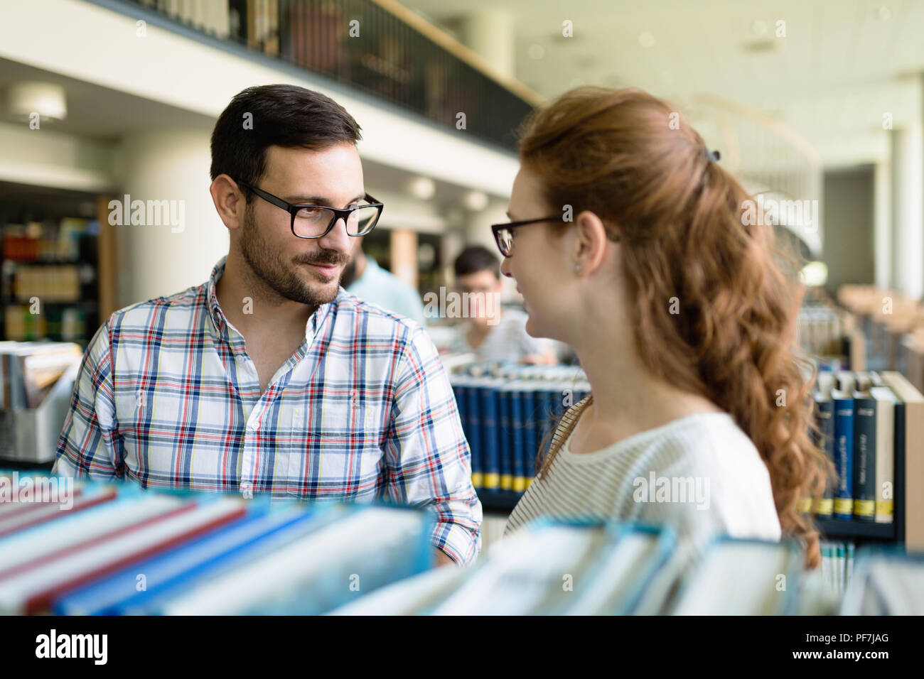 Group of students discussing in university Stock Photo - Alamy