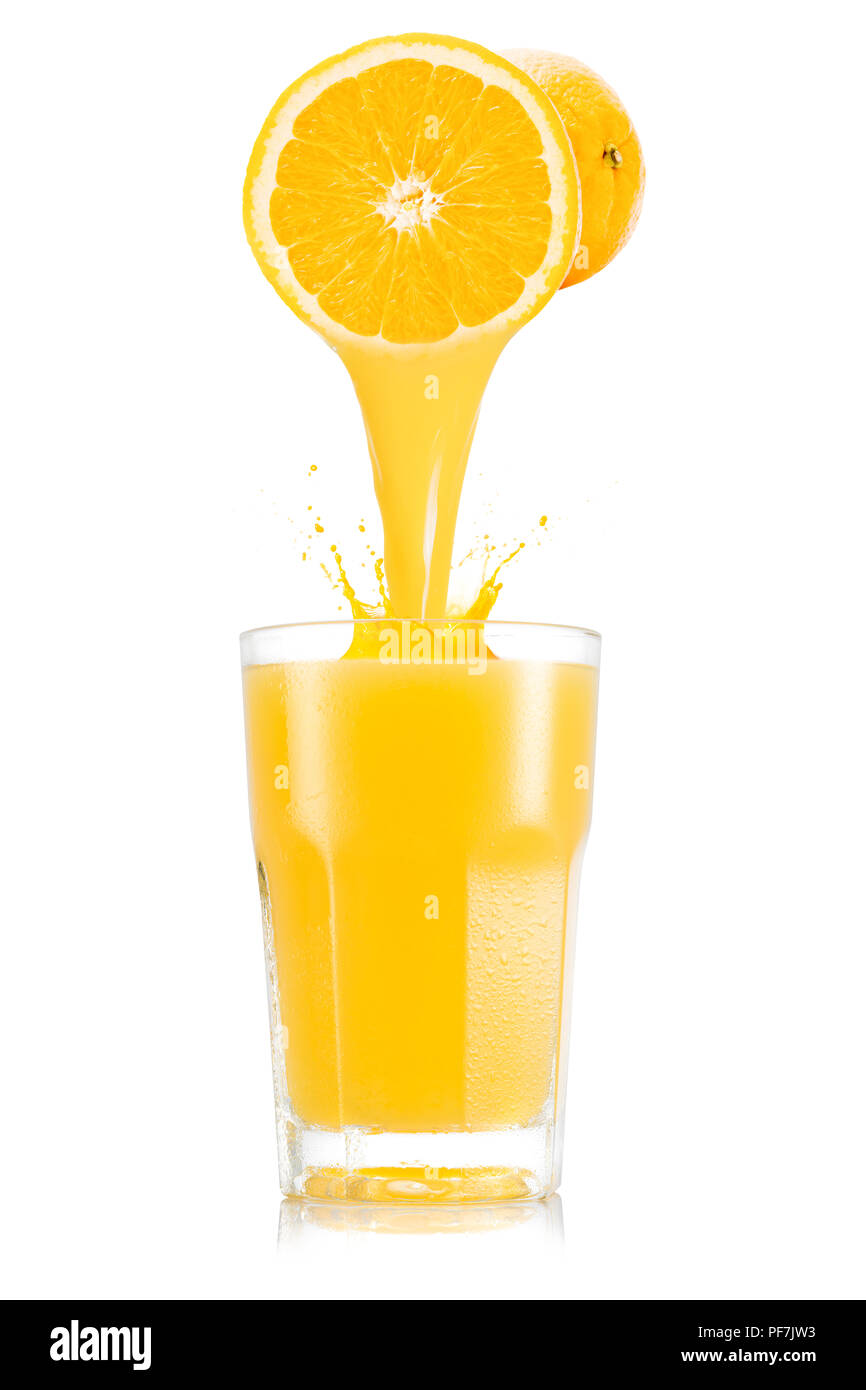 Pure orange juice pouring out from fruit into glass isolated on white ...